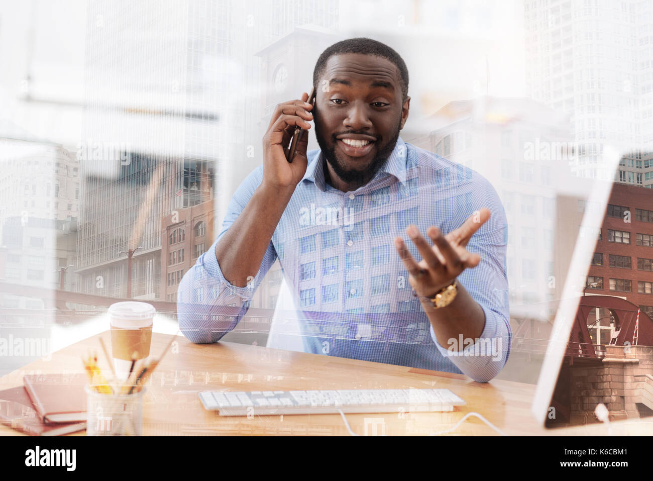 Positive young man communicating on the mobile phone Stock Photo - Alamy