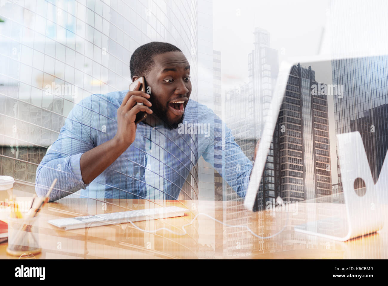 Astonished man looking at the monitor Stock Photo - Alamy