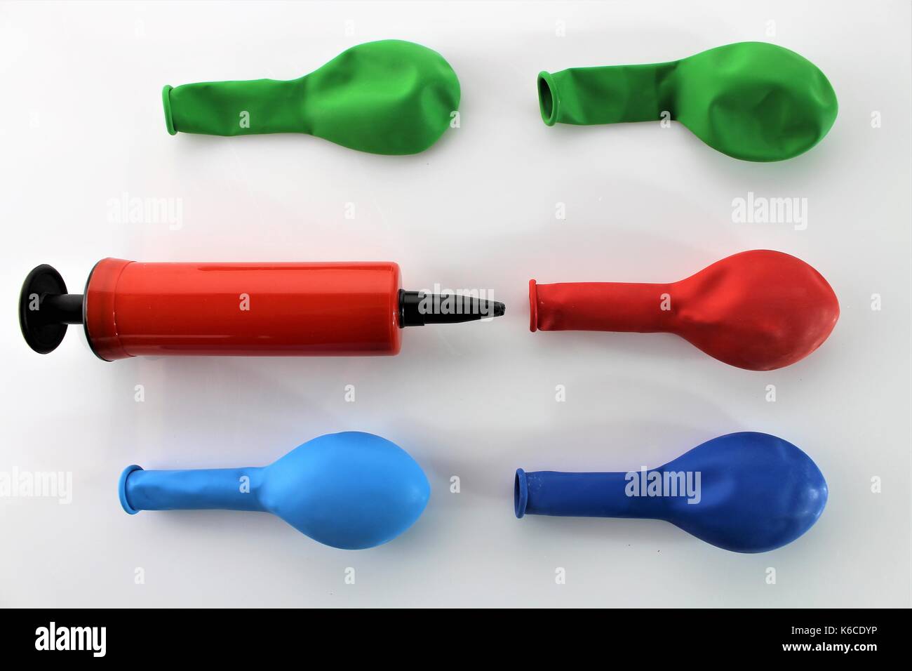 An image of a white air-pump inflating a blue balloon on a white ...