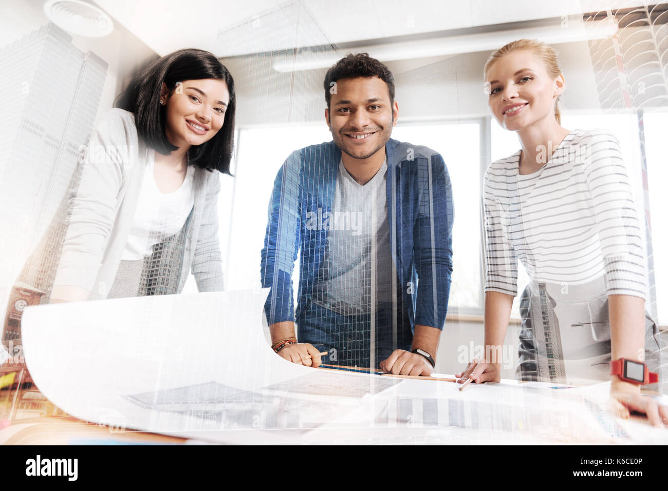 Happy coworkers smiling at you Stock Photo - Alamy