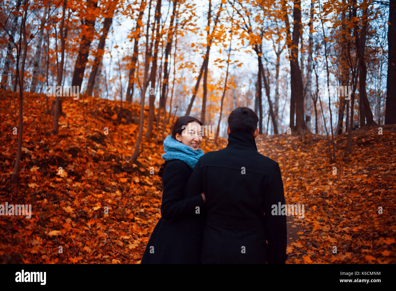 Autumn date, a charming young couple walking together Stock Photo - Alamy