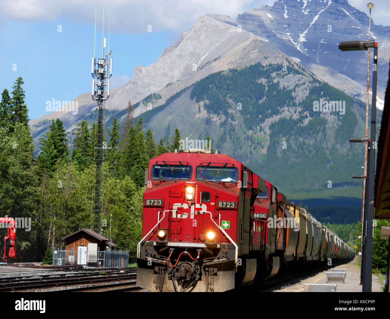 A Canadian Pacific freight train passes through Banff, Canada, with Mount Norquay in the ...