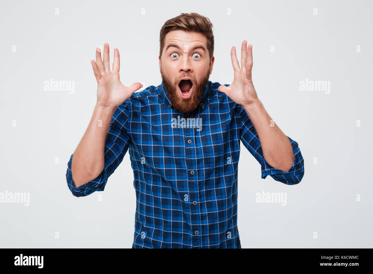 Screaming shocked bearded man in casual looking camera and screaming ...