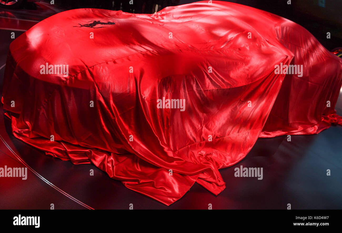 The new Ferrari is covered with a red cloath before its unveiling at ...