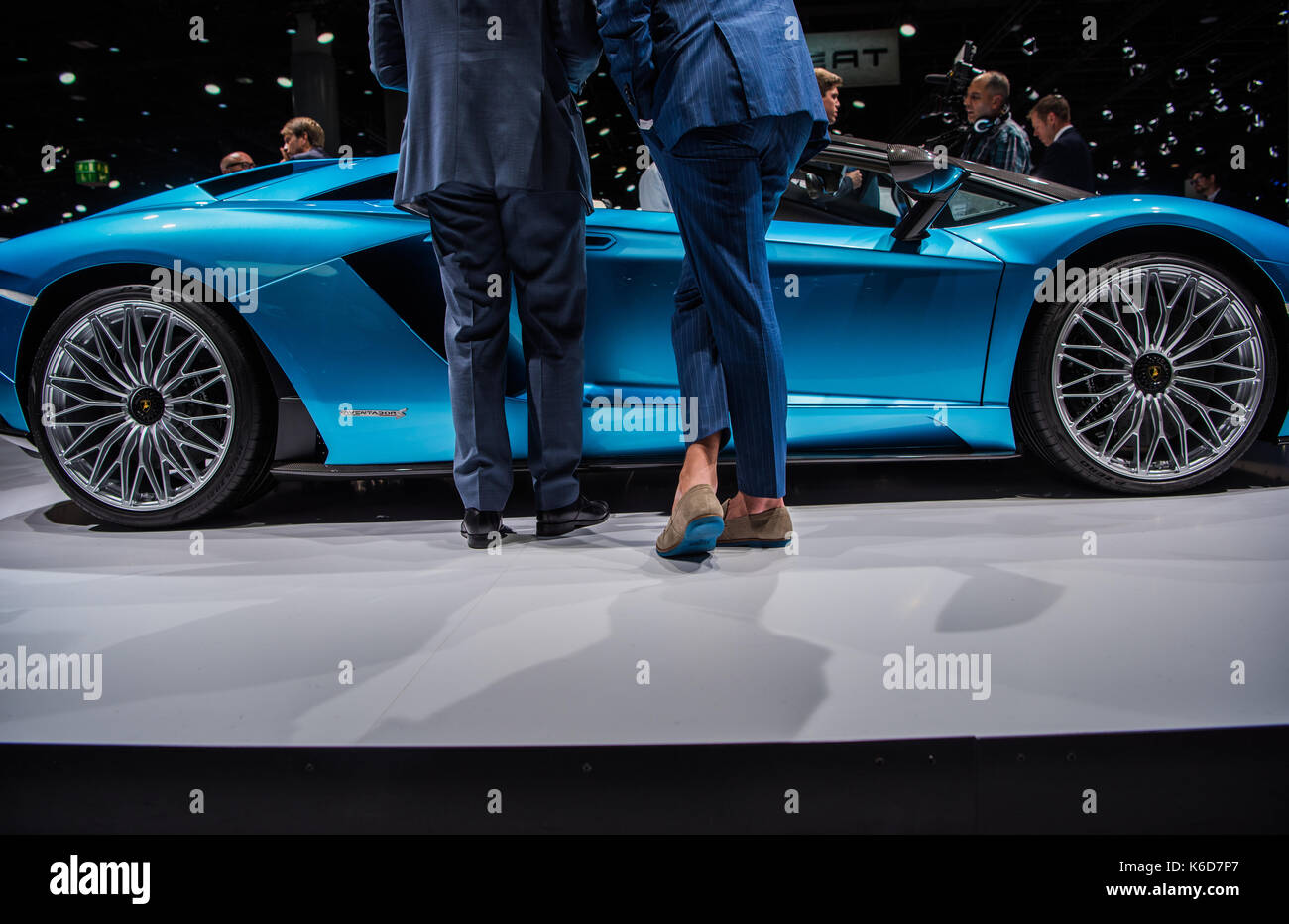 Two men stand in front of the Lamborghini Aventador S Roadster at the ...
