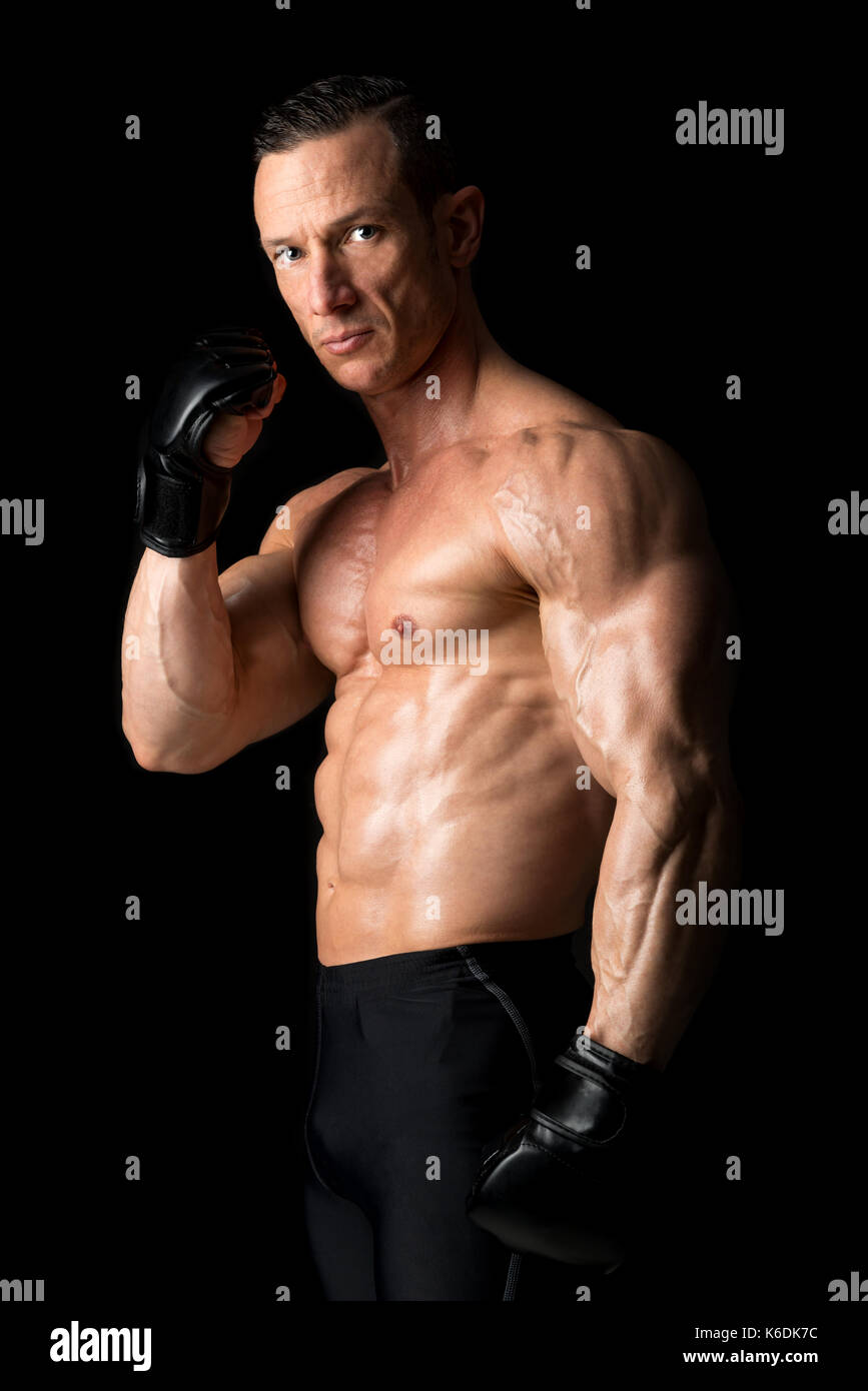 Strong Mixed Martial Arts fighter isolated in black Stock Photo - Alamy