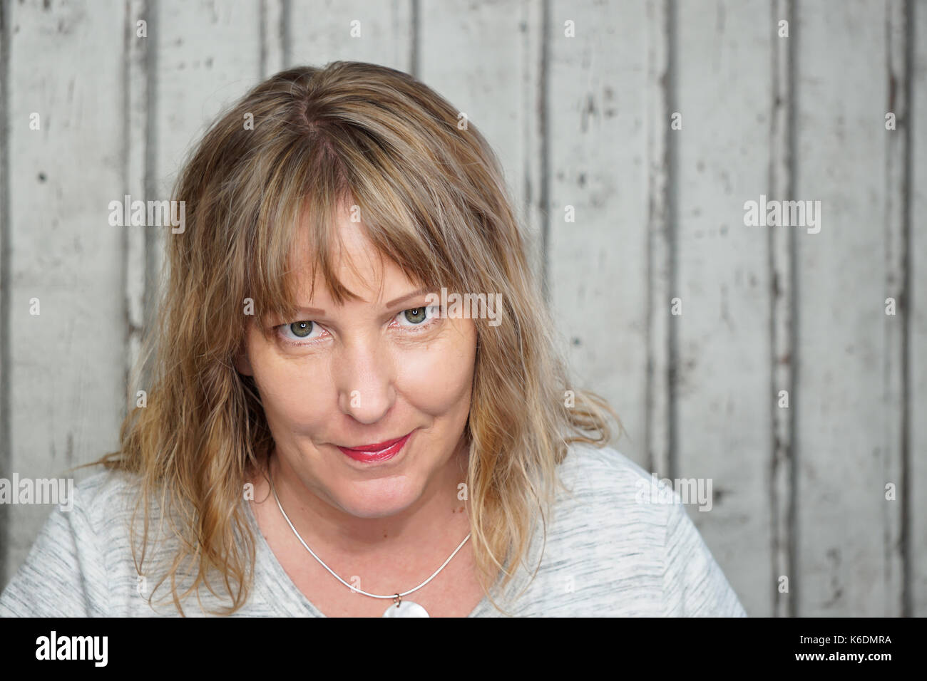Woman looking mischievous portrait Stock Photo - Alamy