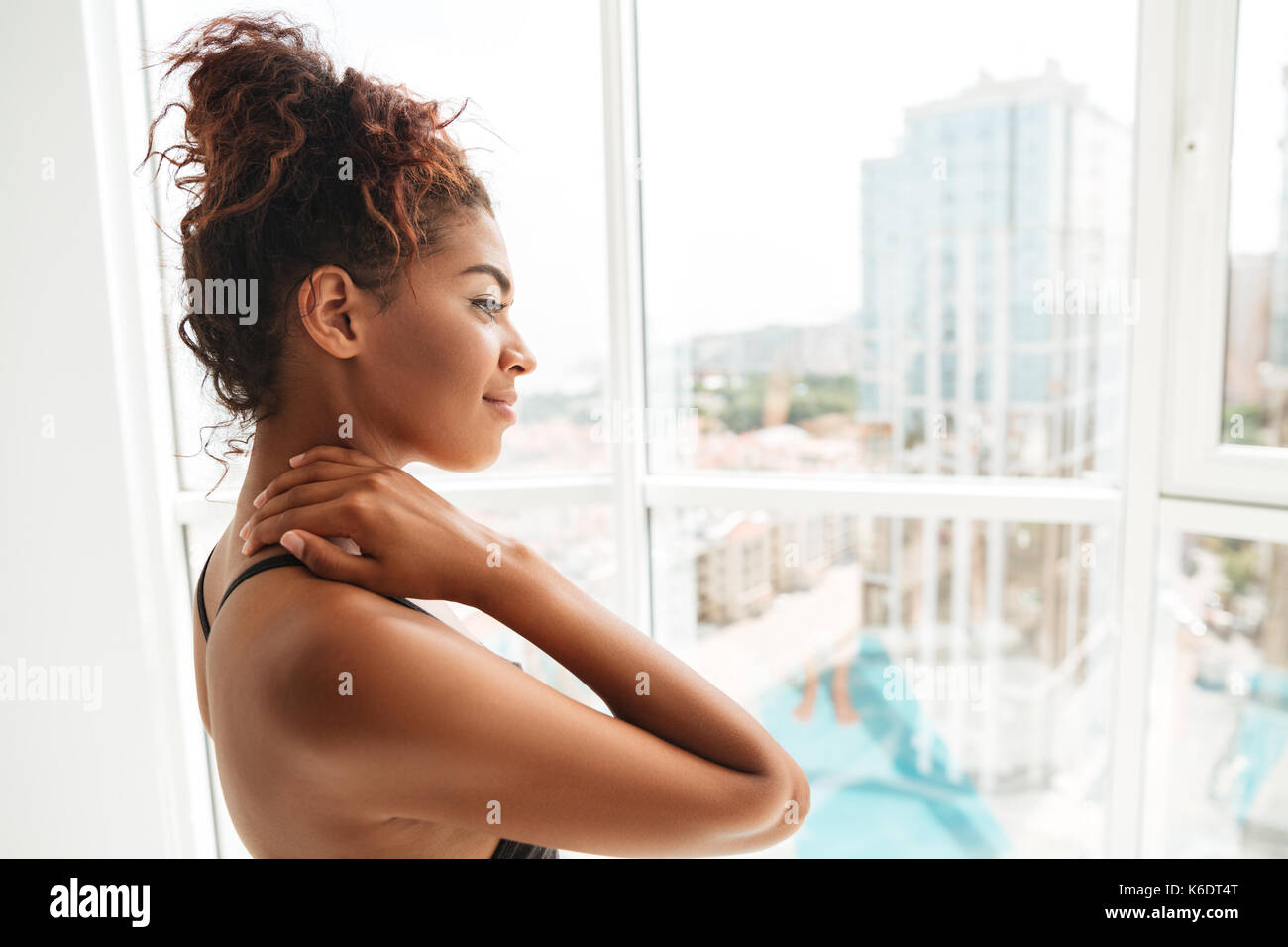 Side view of african confident beautiful woman in sportswear looking in ...