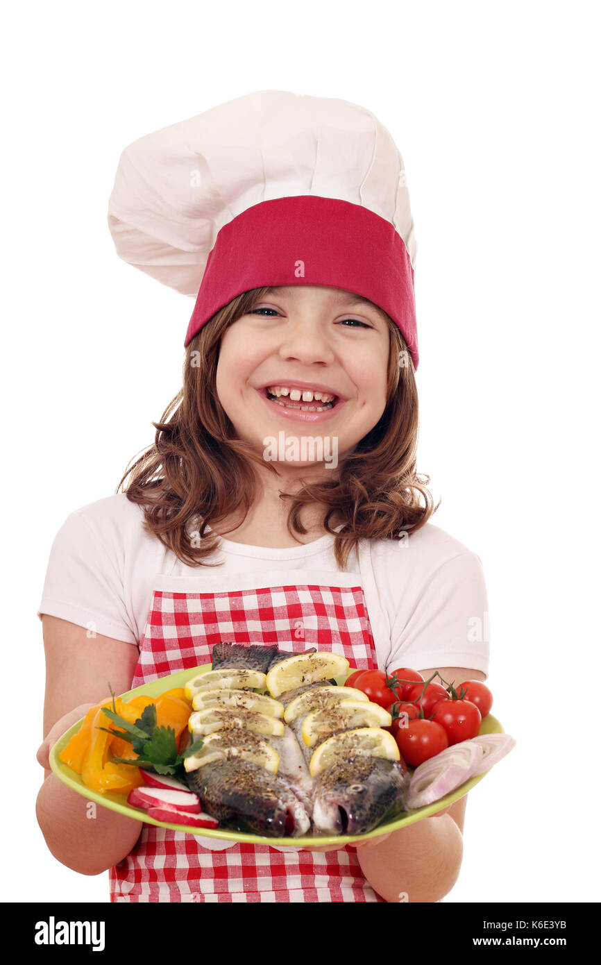 happy little girl cook with fish Stock Photo - Alamy