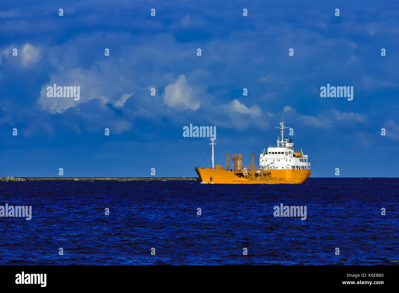 Yellow cargo tanker ship moving at the clear summer day Stock Photo - Alamy