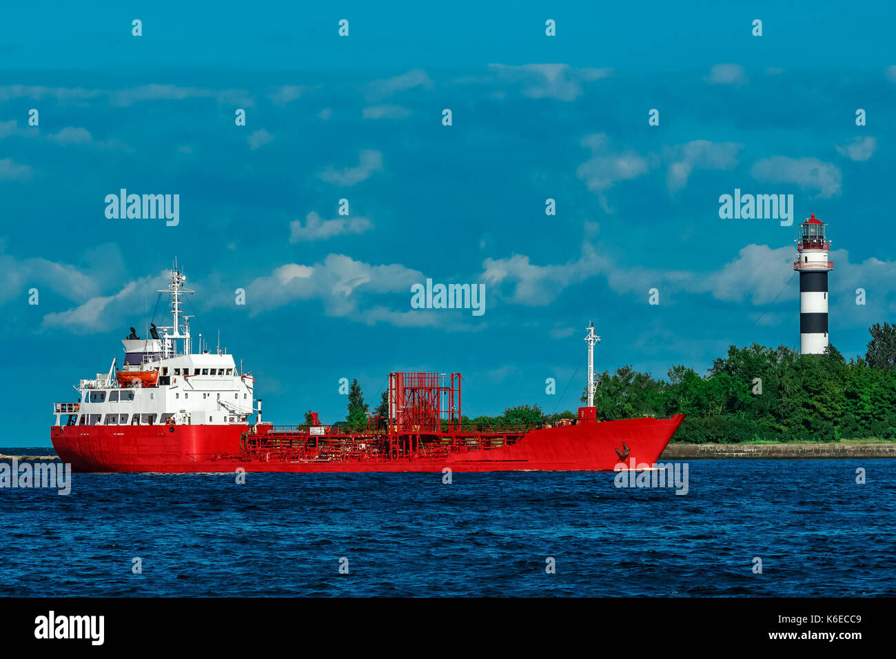 Red cargo tanker ship moving by the river Stock Photo - Alamy