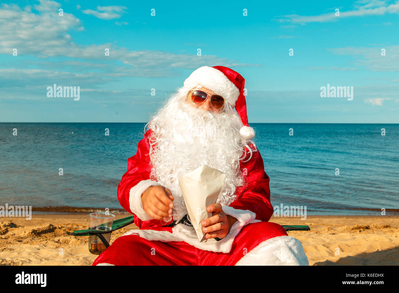 Santa Claus is resting on the beach with beer Stock Photo - Alamy