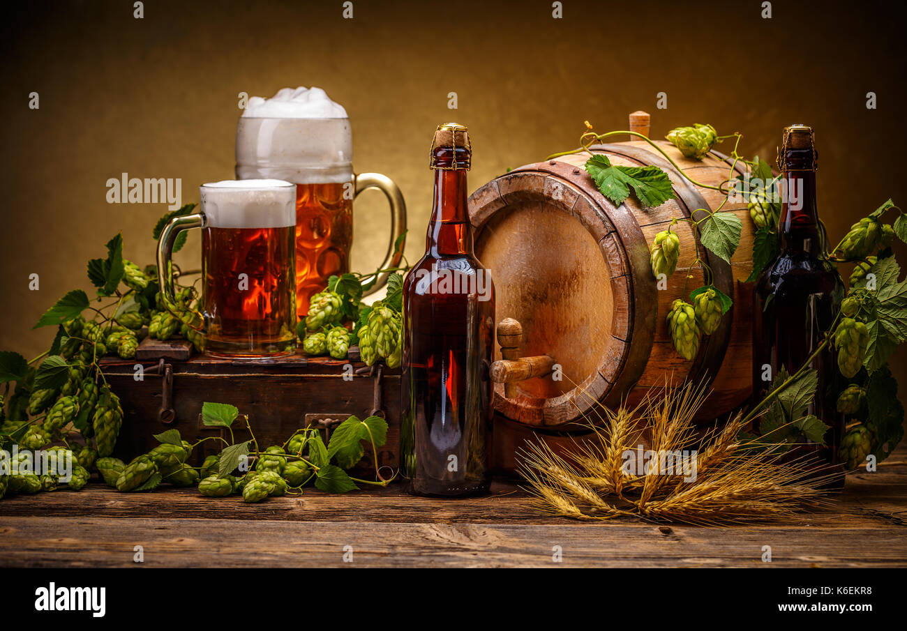 Still life with beer on rustic wooden background Stock Photo - Alamy