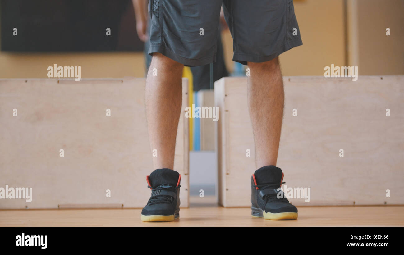 Man sportsman in sneakers - in the gym Stock Photo - Alamy