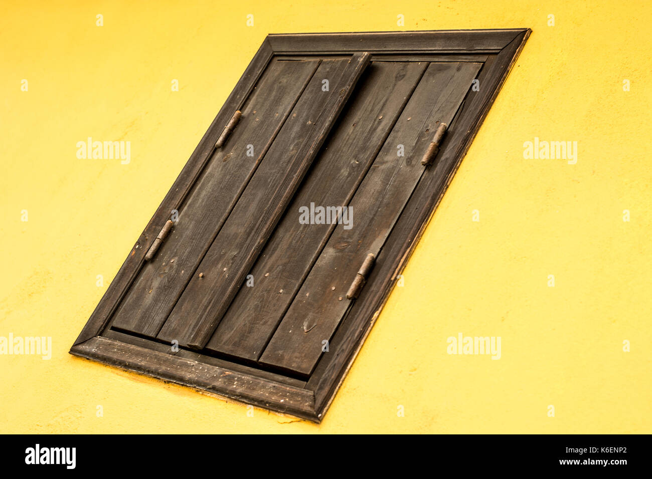 Yellow wall with wooden brown window. Abstract perspective composition ...