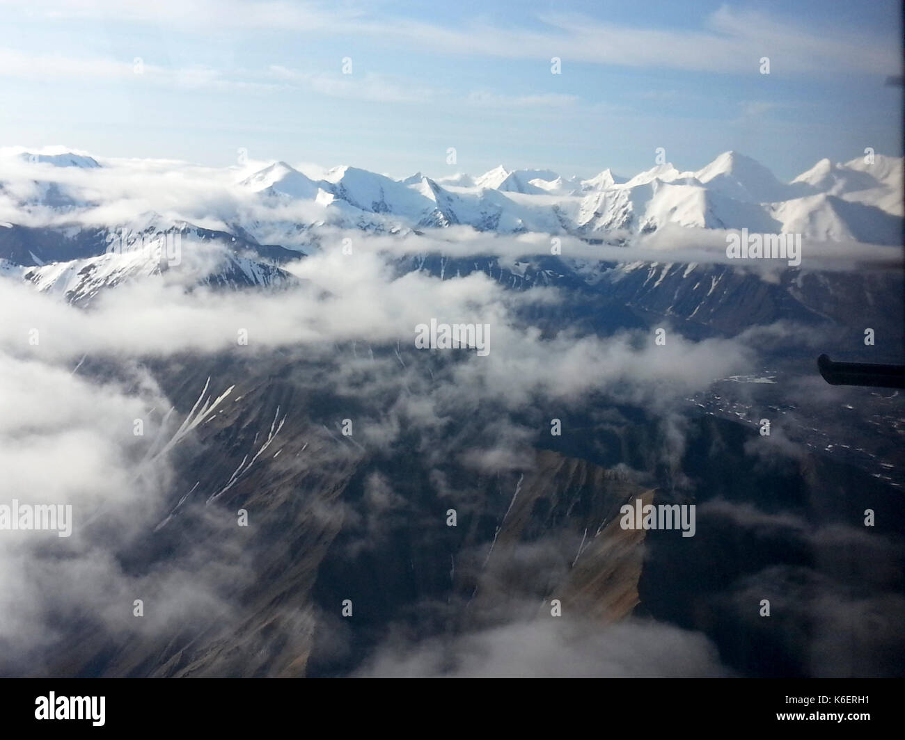 AERIAL VIEW FROM TOURING AIRPLANE OF SNOW CAPPED MOUNTAINS, ALASKA ...