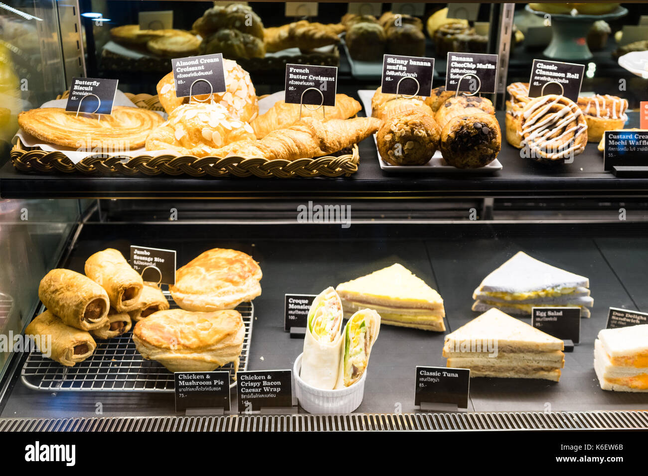 Variety of tasty pastry in glass display Stock Photo - Alamy