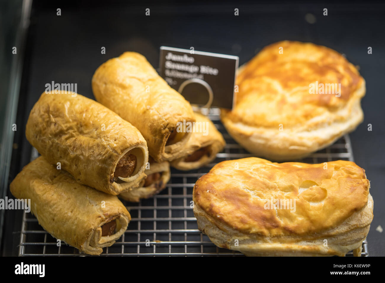 Variety of tasty pastry in glass display Stock Photo - Alamy