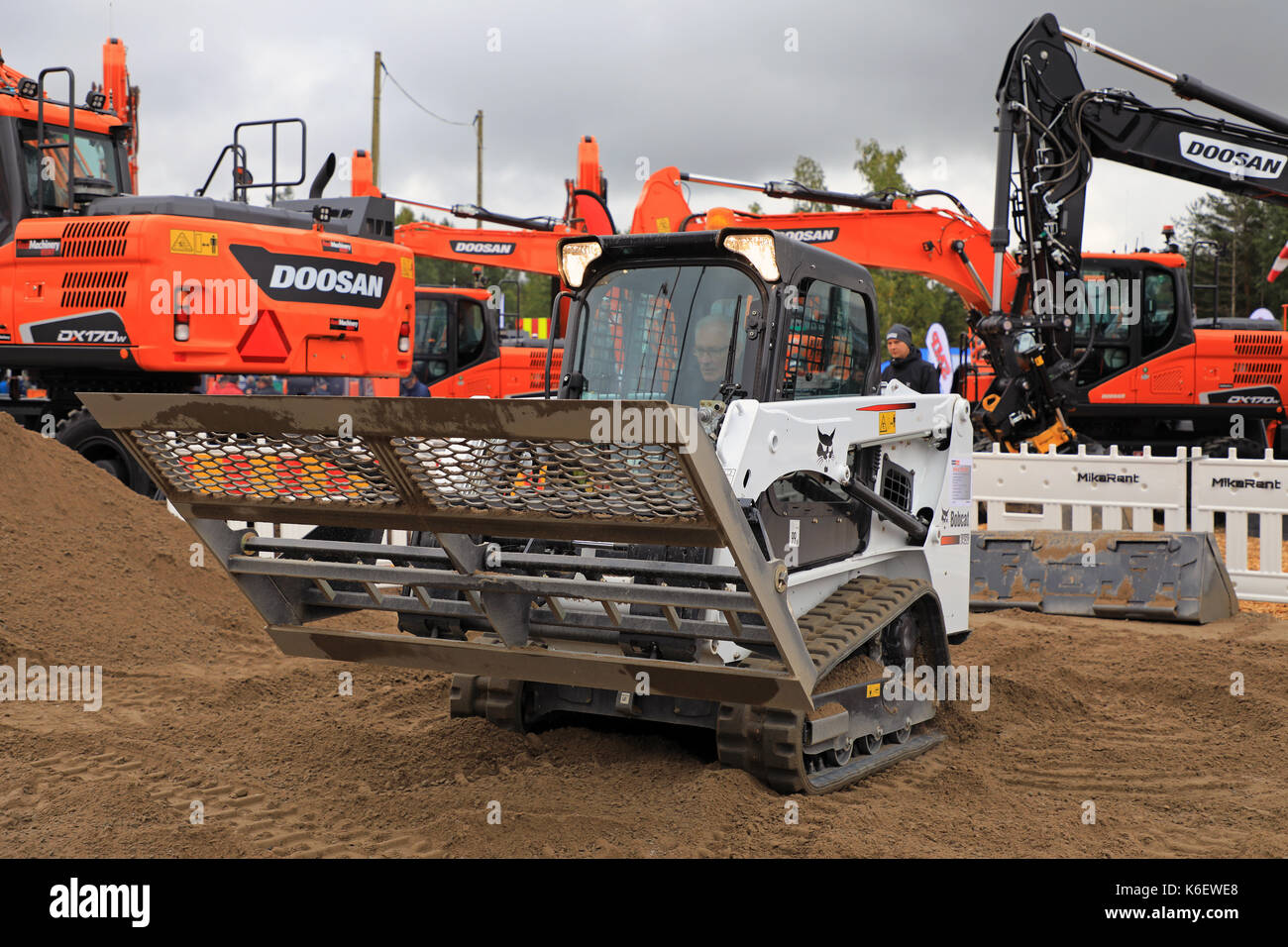 HYVINKAA, FINLAND - SEPTEMBER 8, 2017: Operator works with land leveler ...