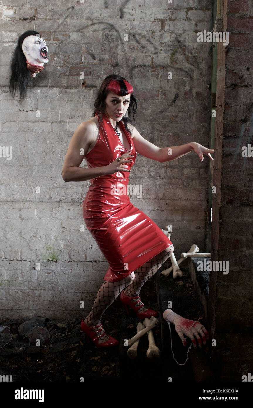 Burlesque performer wearing a red shiny dress in an interior location ...