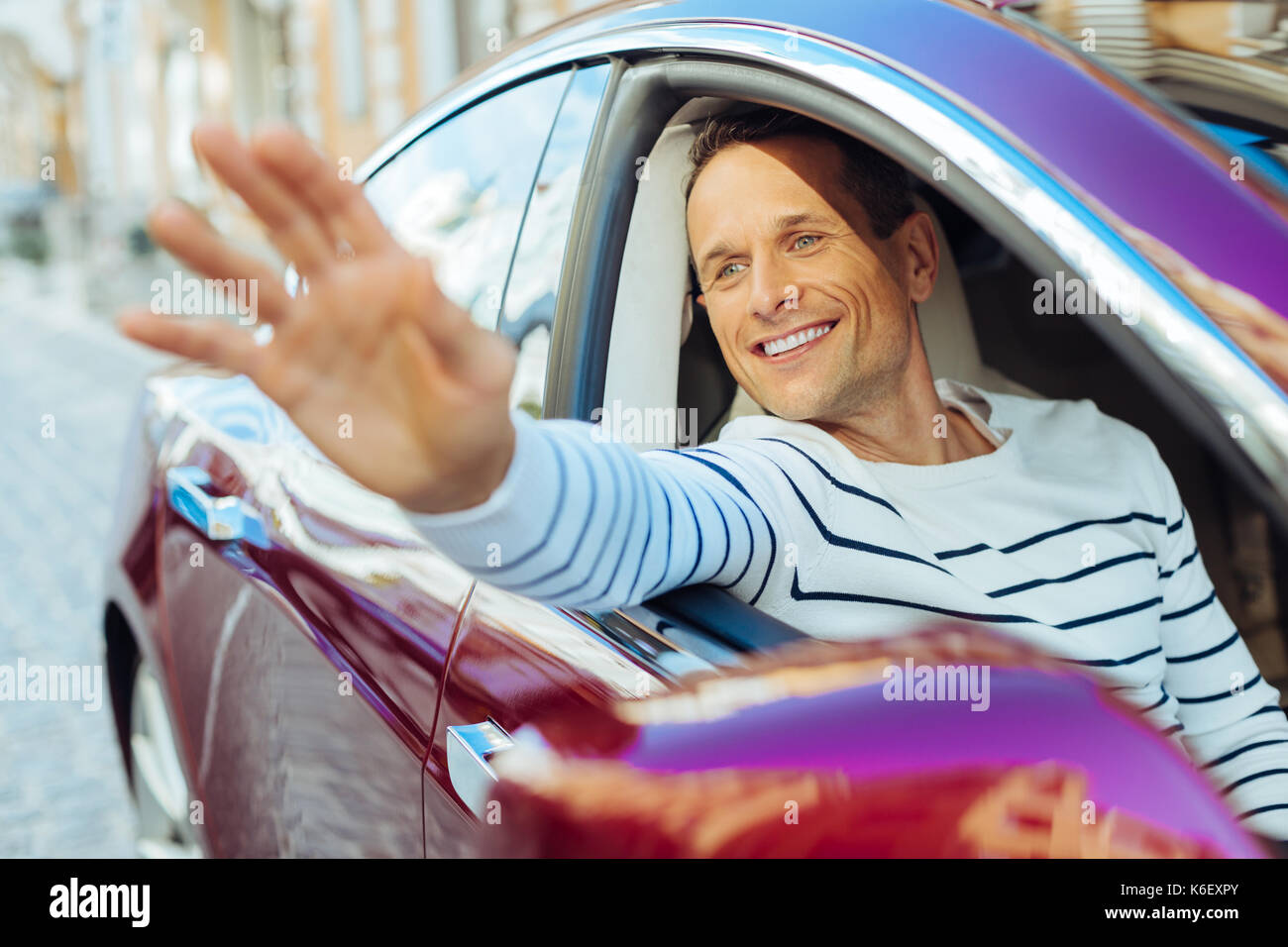 Man waving from auto hi-res stock photography and images - Alamy