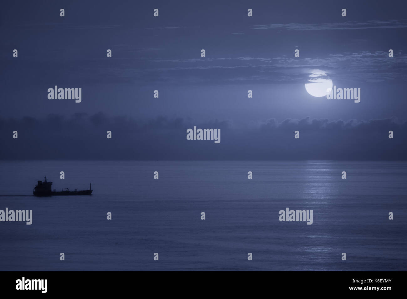 cargo ship at night with moonlight Stock Photo - Alamy