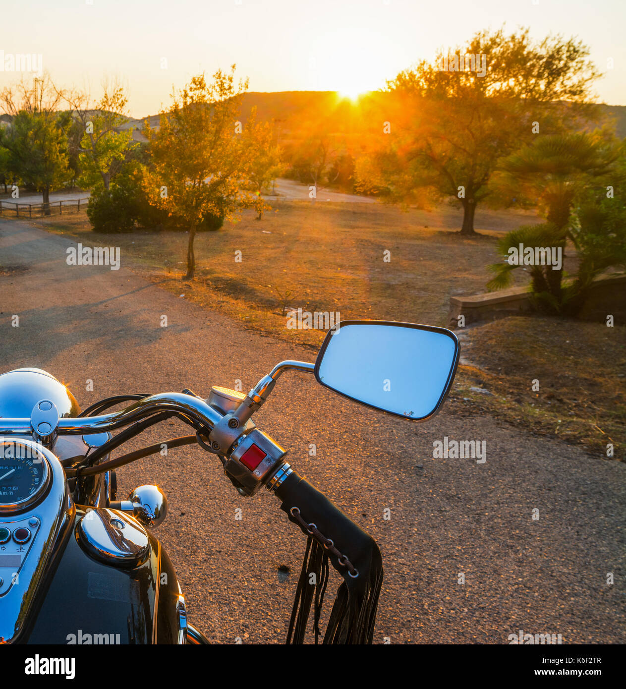Classic motorcycle on a country road at sunset Stock Photo - Alamy