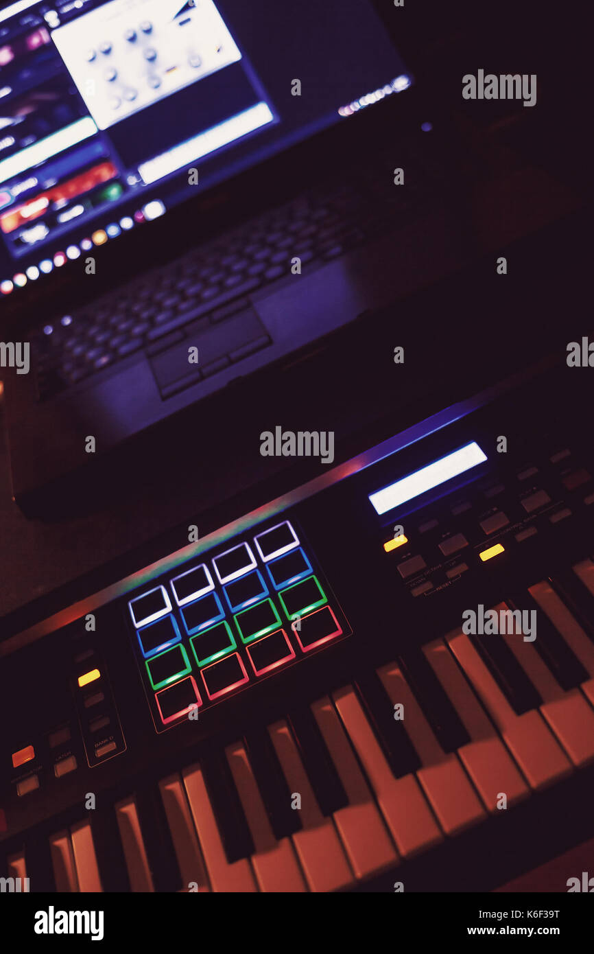 Details of a modern midi keyboard and laptop in blurry background Stock ...