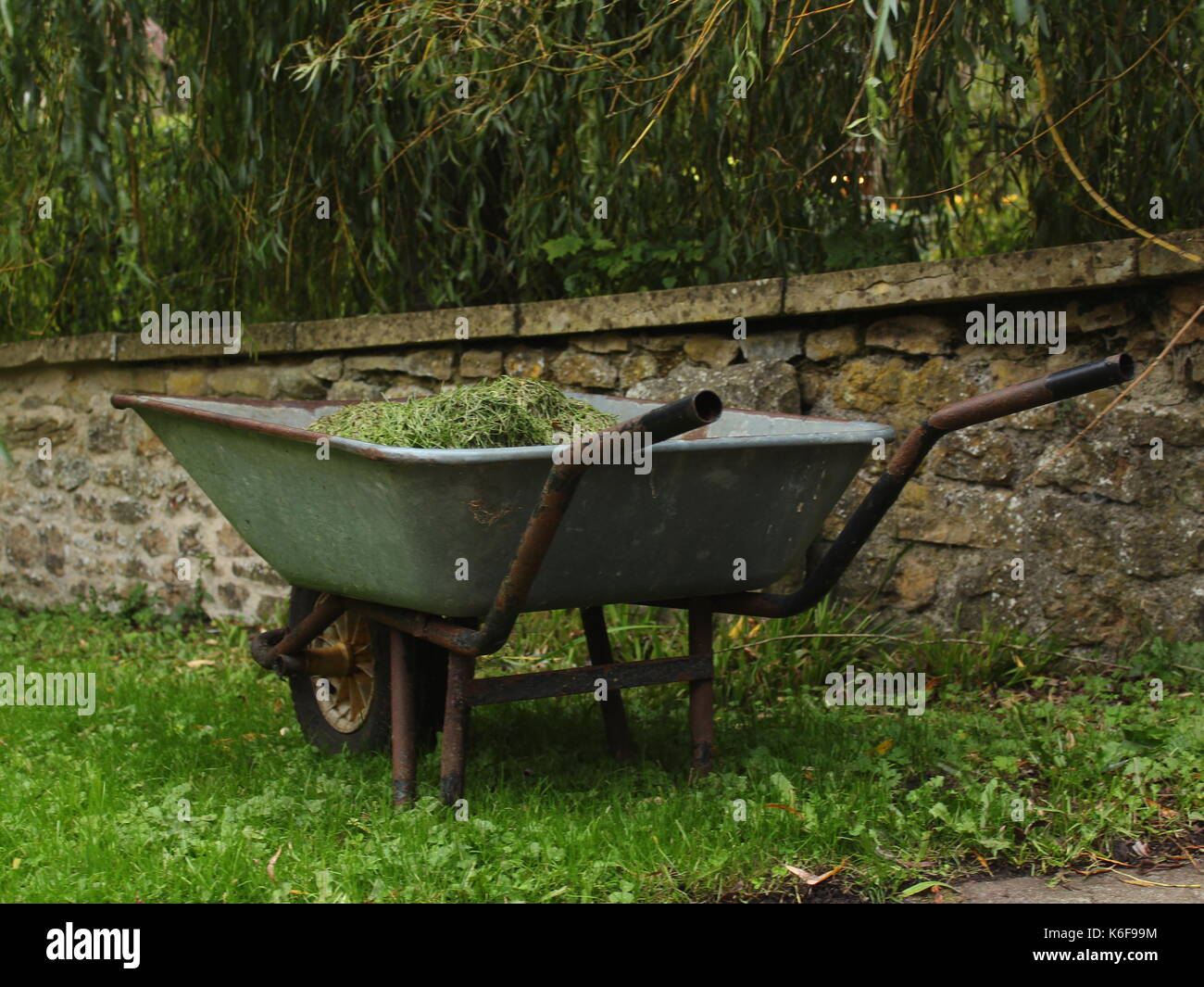 Wooden wheel barrow hi-res stock photography and images - Alamy