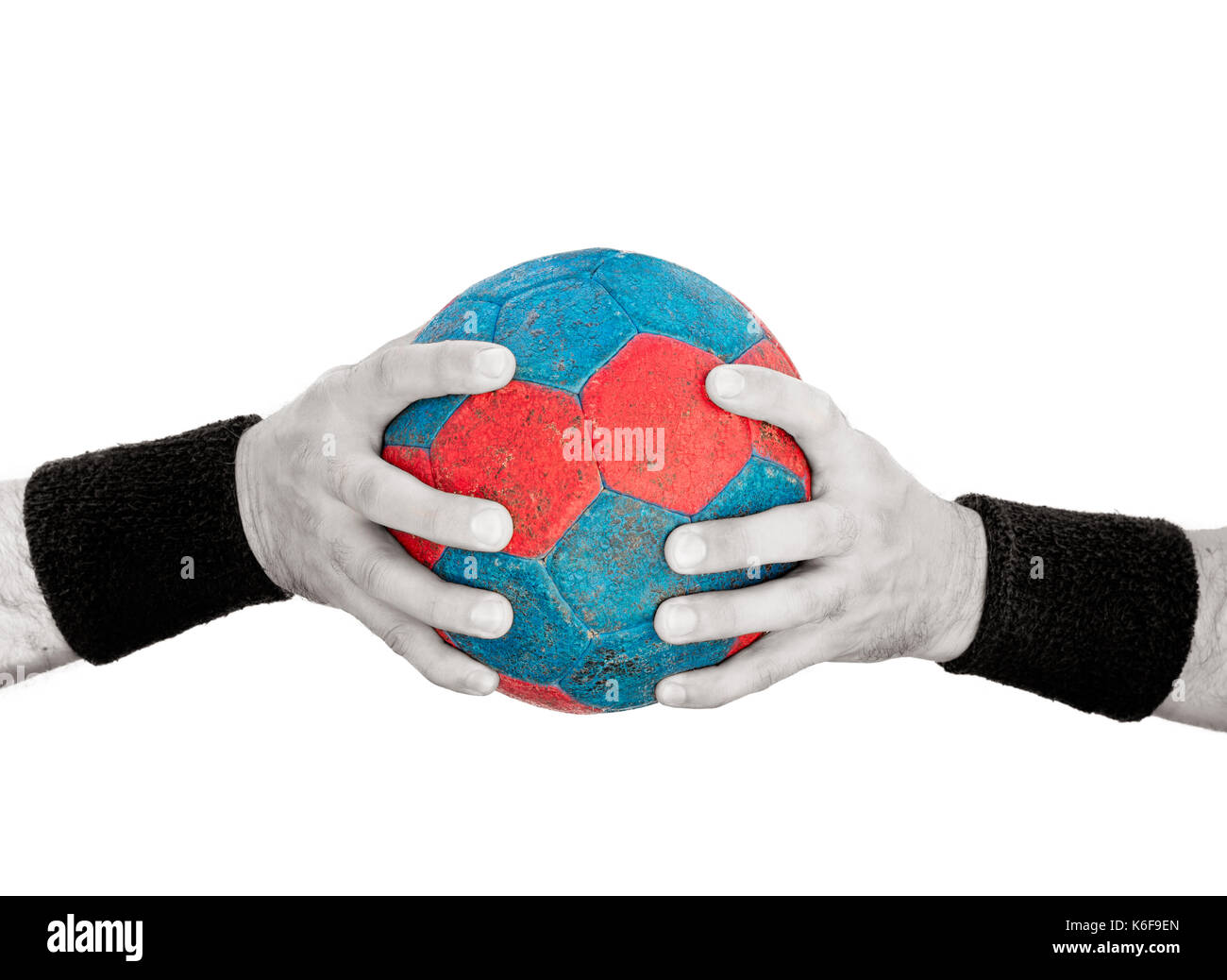 Man's hands on blue and red handball isolated on white, colored ...