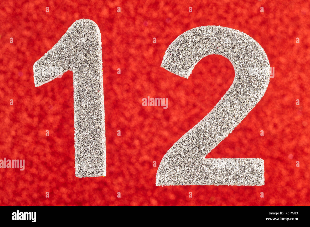 Number twelve silver color over a red background. Anniversary ...