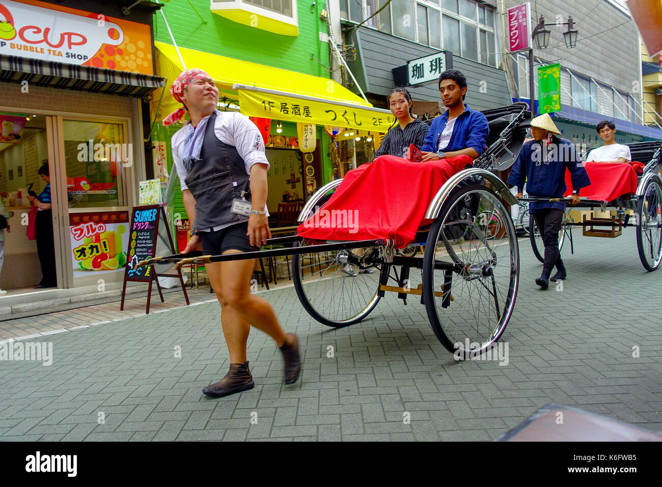 TOKYO, JAPAN JUNE 28 - 2017: Tourists rides a rickshaw at Sensoji ...