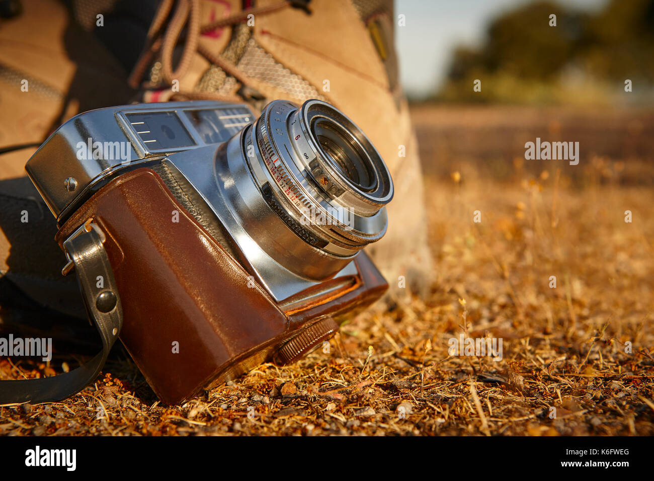 Vintage camera with hiking boots on the ground. Travel background Stock ...