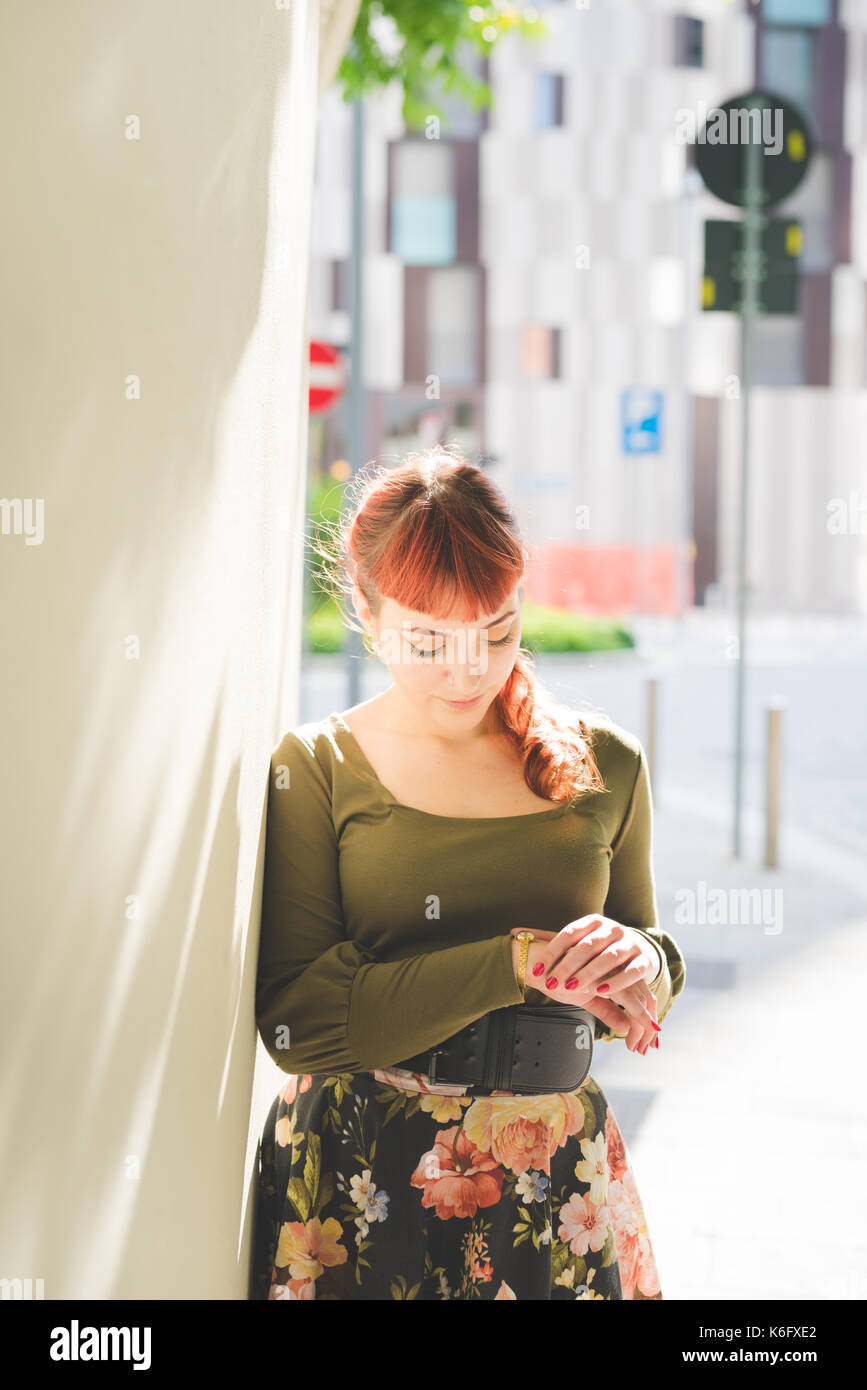 portrait young woman beautiful posing outdoor looking down checking ...