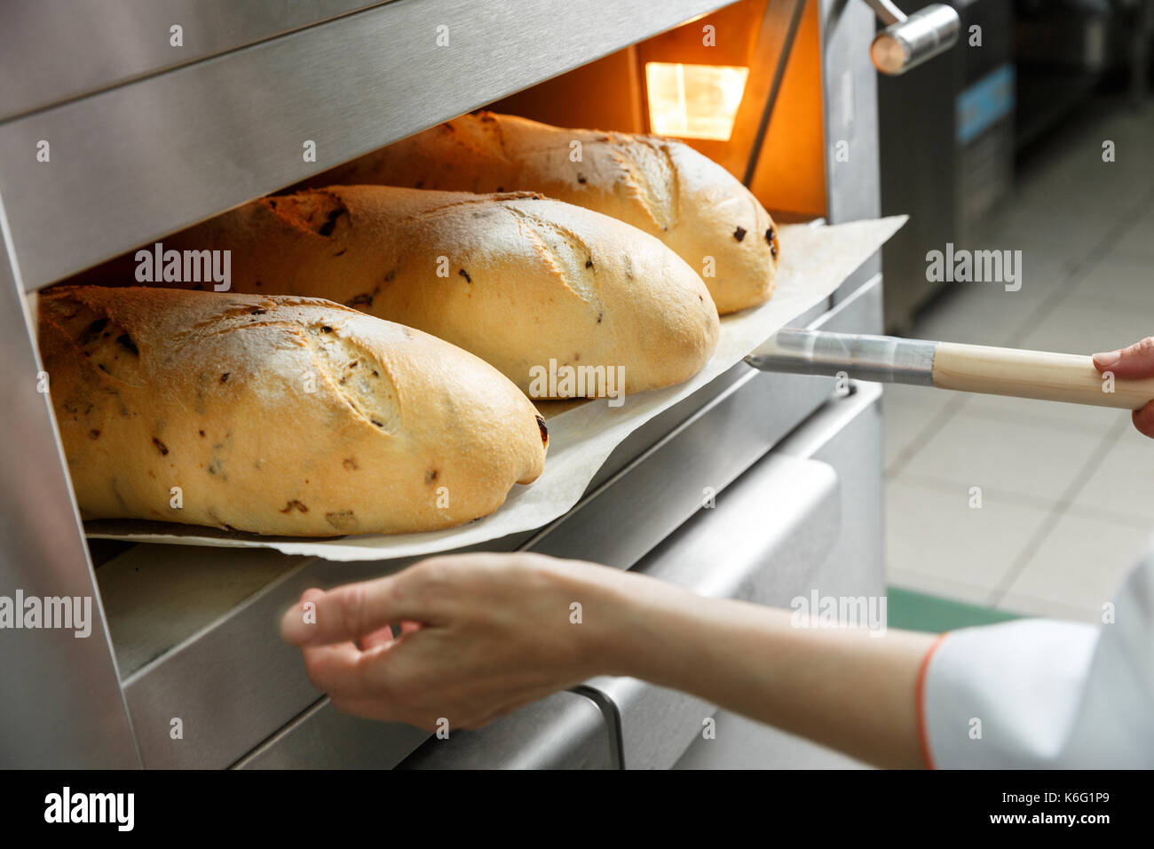 Baker bread oven hands hi-res stock photography and images - Alamy