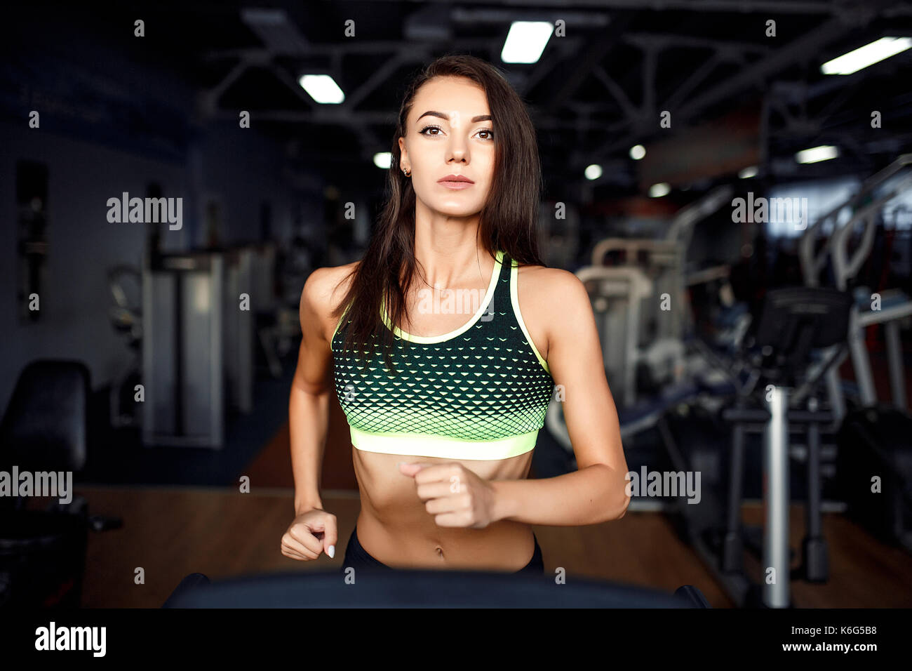 Young fitness woman doing cardio exercises at the gym running on a ...
