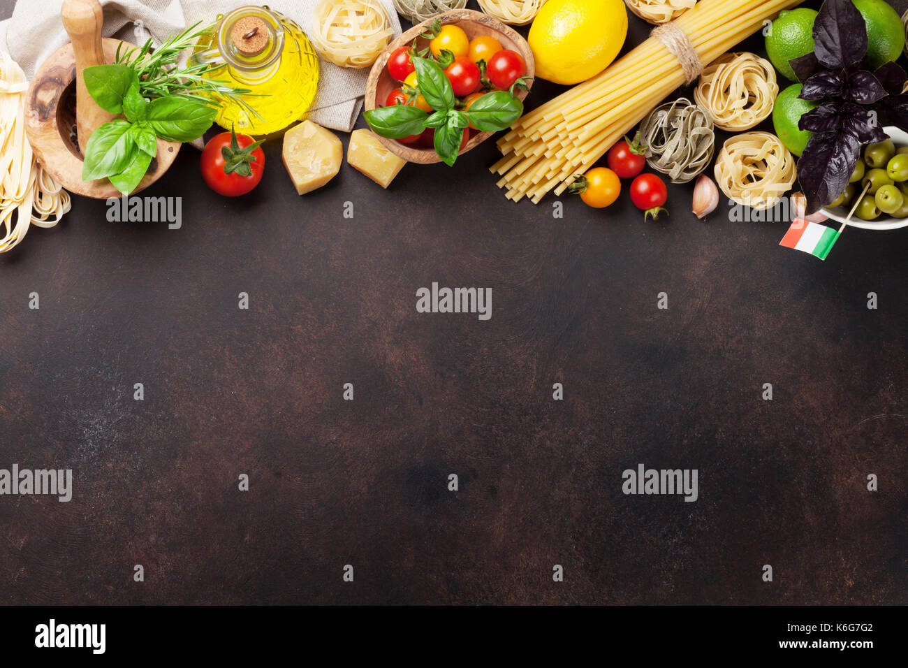 Italian food. Pasta ingredients on stone table. Top view with space for ...