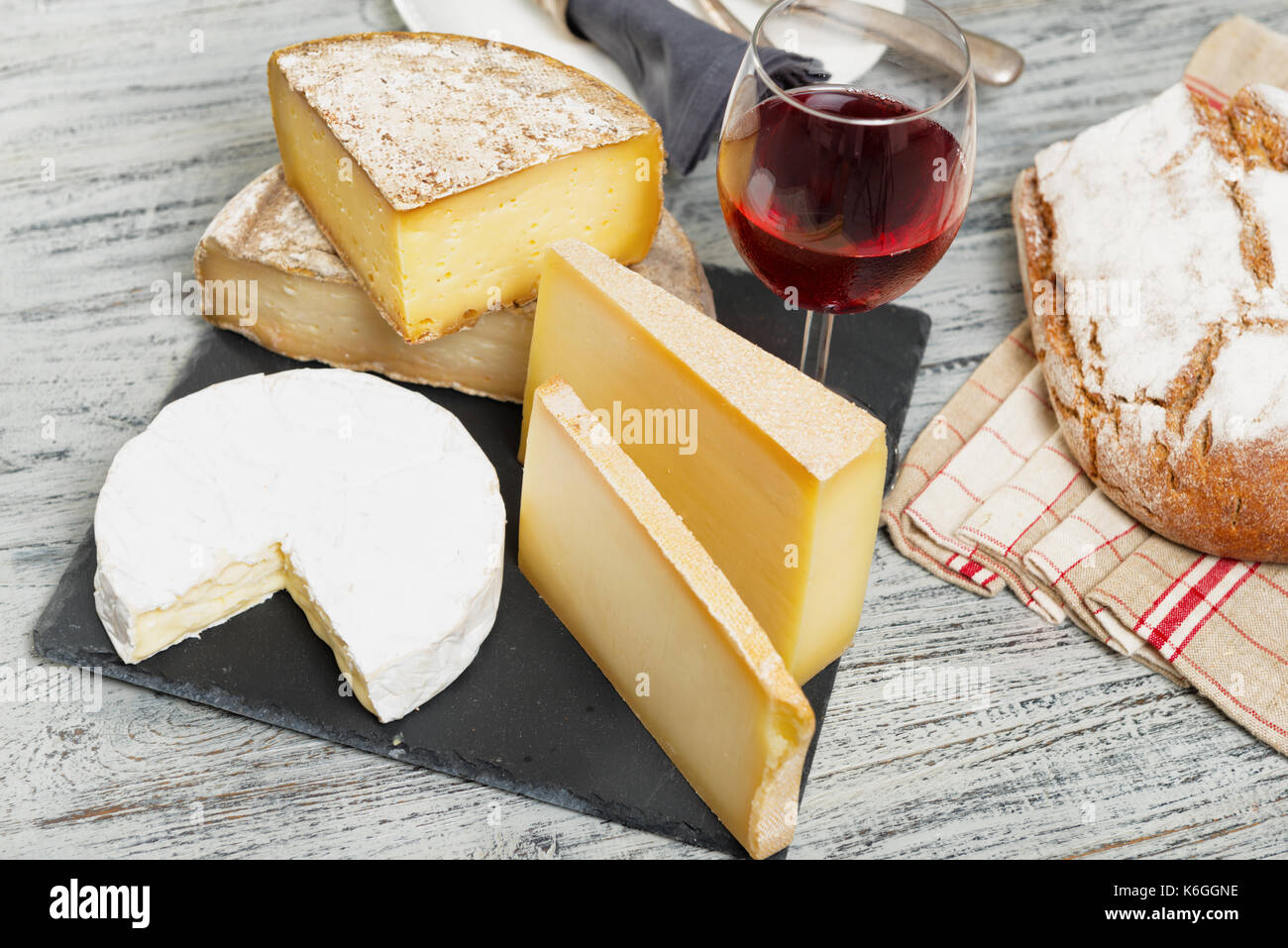 Different french cheeses with a glass of red wine Stock Photo - Alamy