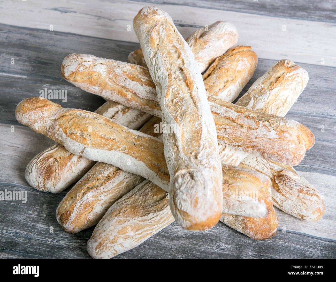 French bread stick on a rustic table Stock Photo - Alamy