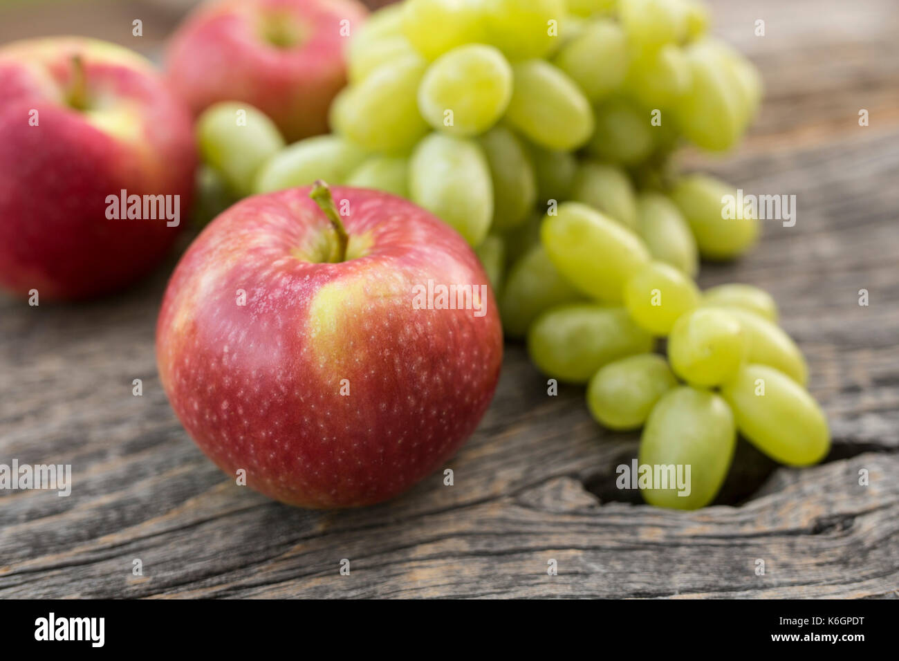 Close up of a vintage table with apples on the foreground and raison at ...