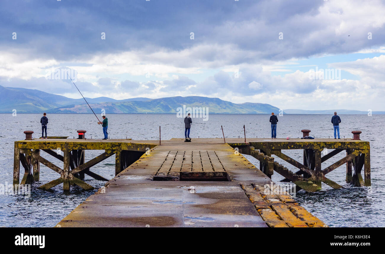 Five males fishing at the end of the abandoned pier at Portencross ...