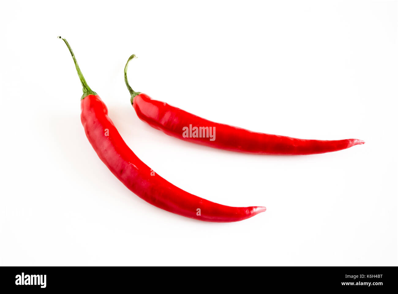 Two red peppers on white background Stock Photo - Alamy