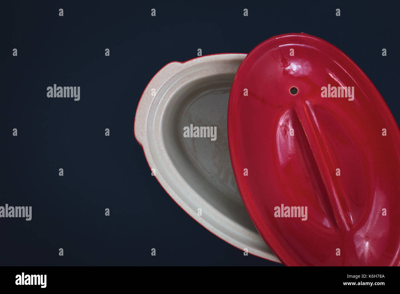 Red Ceramic bowl for oven on black background Stock Photo - Alamy