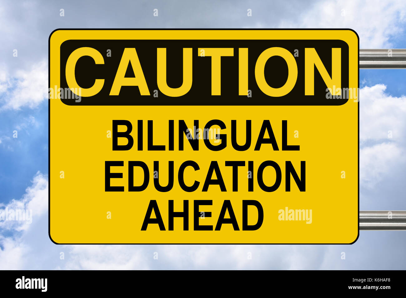 Bilingual education ahead, yellow warning road sign Stock Photo - Alamy