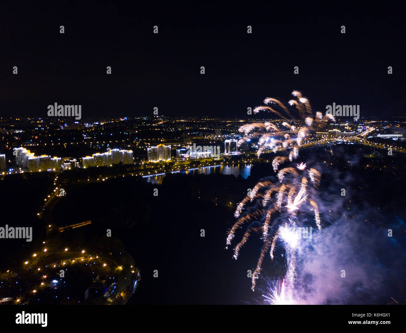 Firework shoot from drone. River and night city view. Musical festival ...