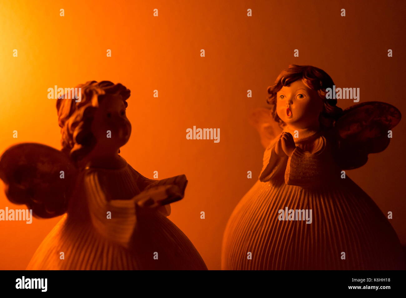 two little angels sitting opposite Stock Photo - Alamy