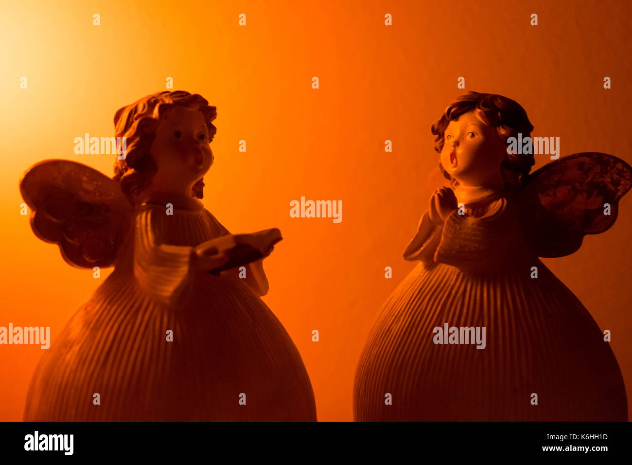 two little angels sitting opposite Stock Photo - Alamy