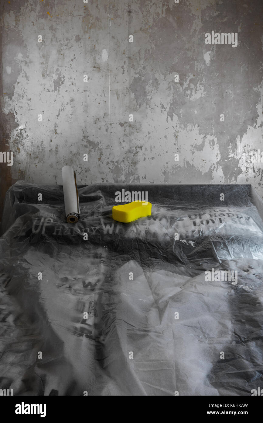 Decorating / redecorating a UK bedroom with dust sheet on bed, old ...