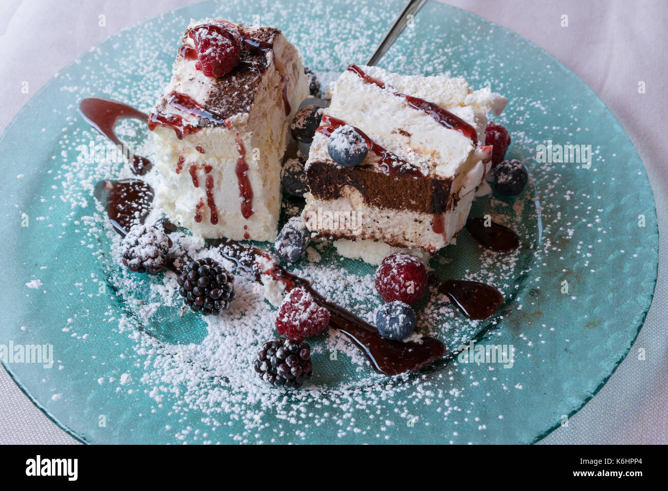 Sweet meringue cake(Pavlova) with fresh winter berry fruits on glass ...