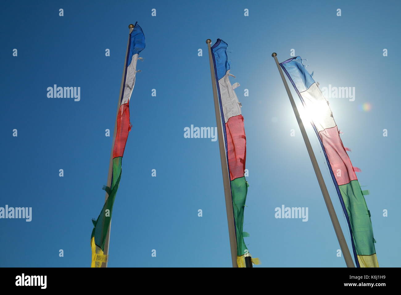 Colored flags in front of the sun Stock Photo - Alamy